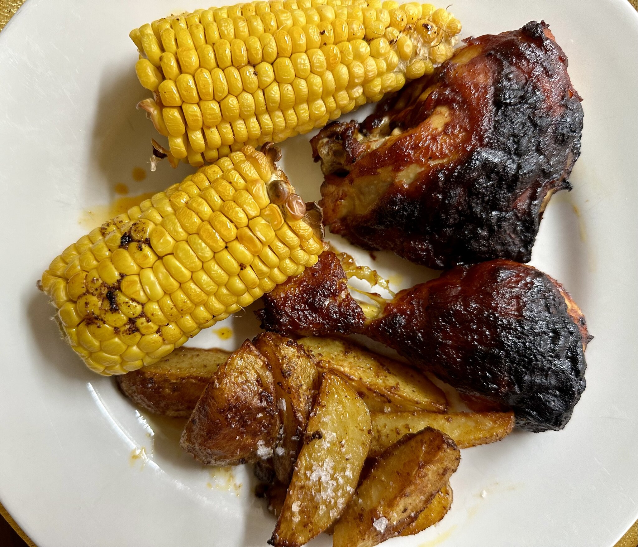 Friday evening barbecued chicken with corn on the cob and potato wedges ...